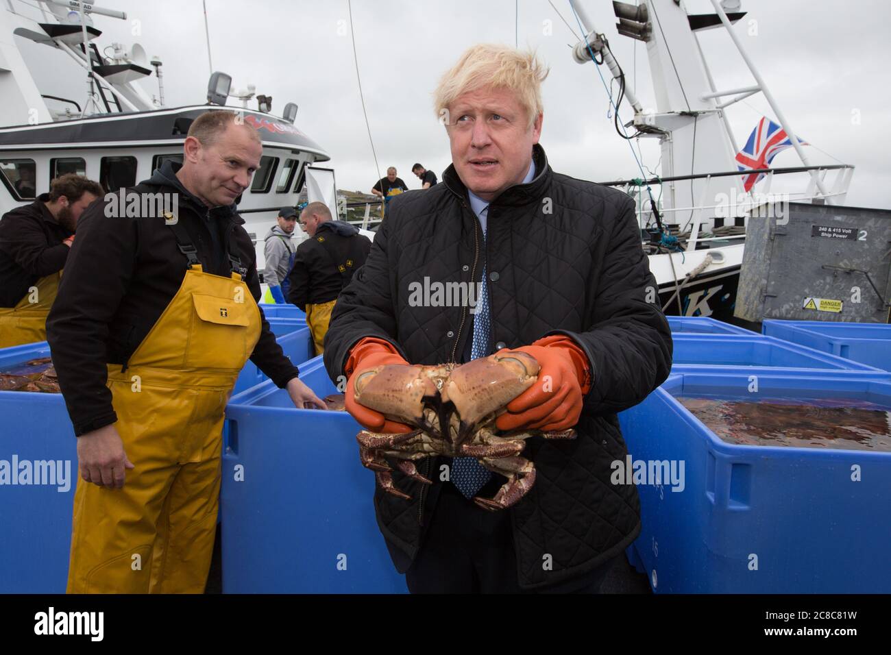 Prime Minister Boris Johnson holds a crab caught on the Carvela with ...