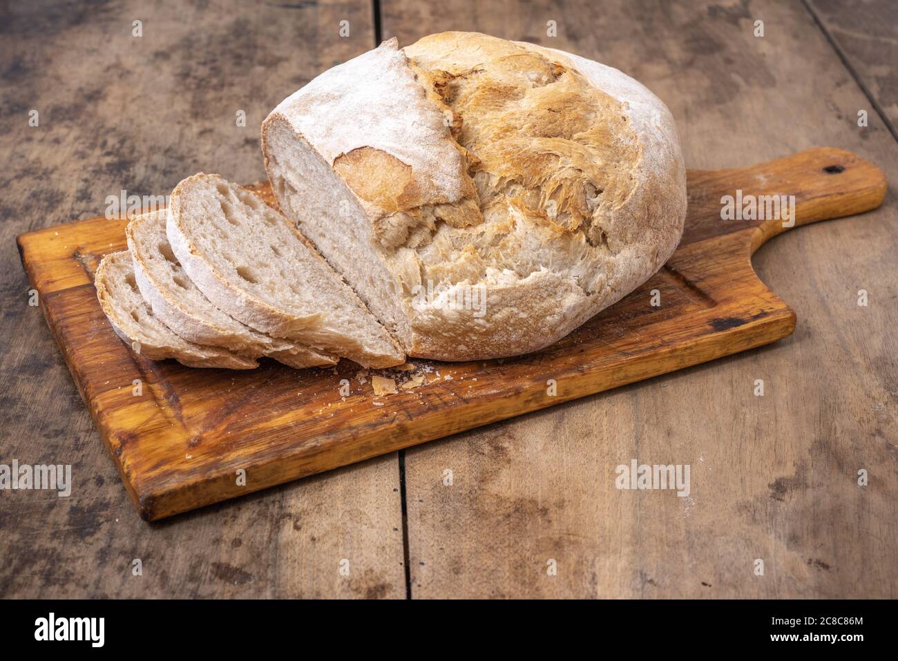 Sliced organic wheat bread and flour on a table Stock Photo - Alamy