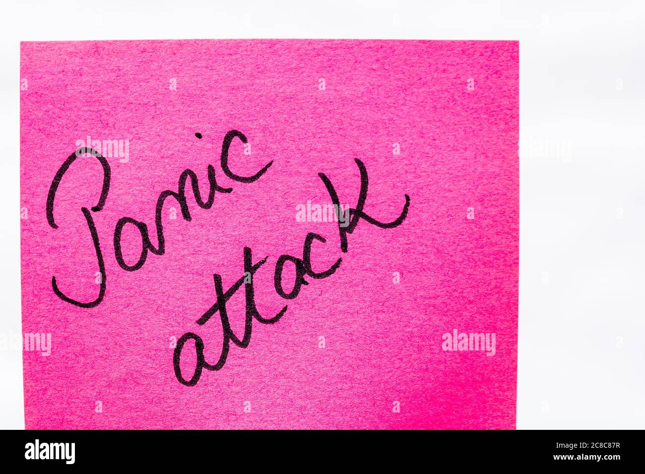 Panic attack handwriting text close up isolated on pink paper with copy ...