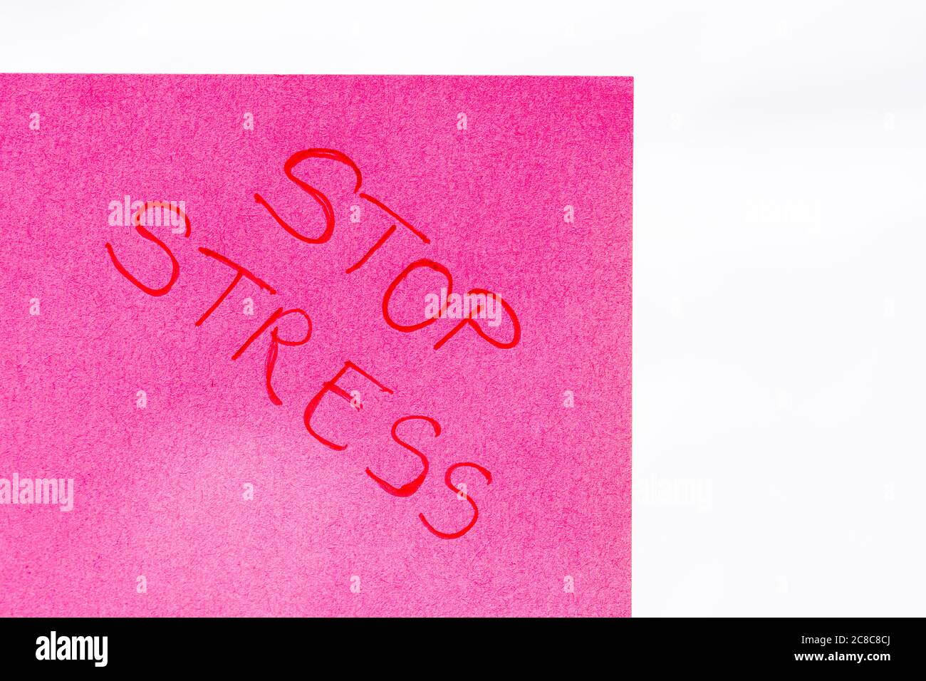 Stop stress handwriting text close up isolated on pink paper with copy ...