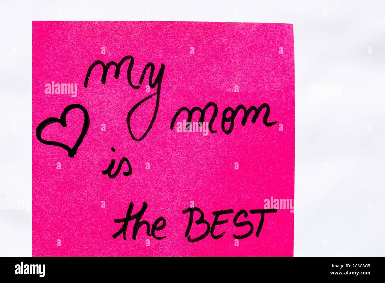 My mom is the best handwriting text close up isolated on pink paper ...