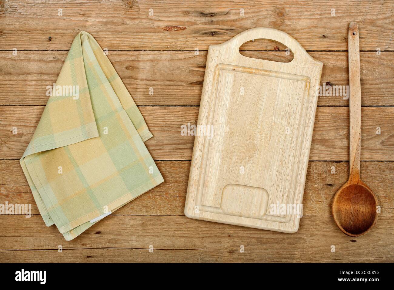 napkin, cutting board and ladle on wooden surface Stock Photo - Alamy