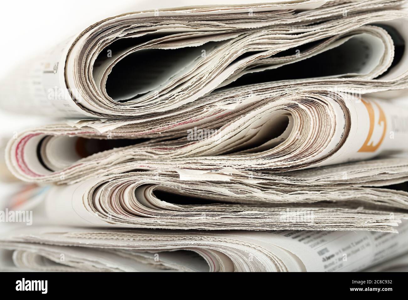 stack of folded newspapers closeup Stock Photo - Alamy