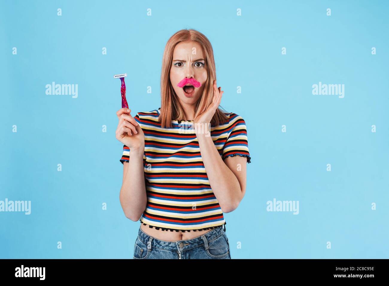 Image of beautiful shocked woman with fake mustache holding razor ...
