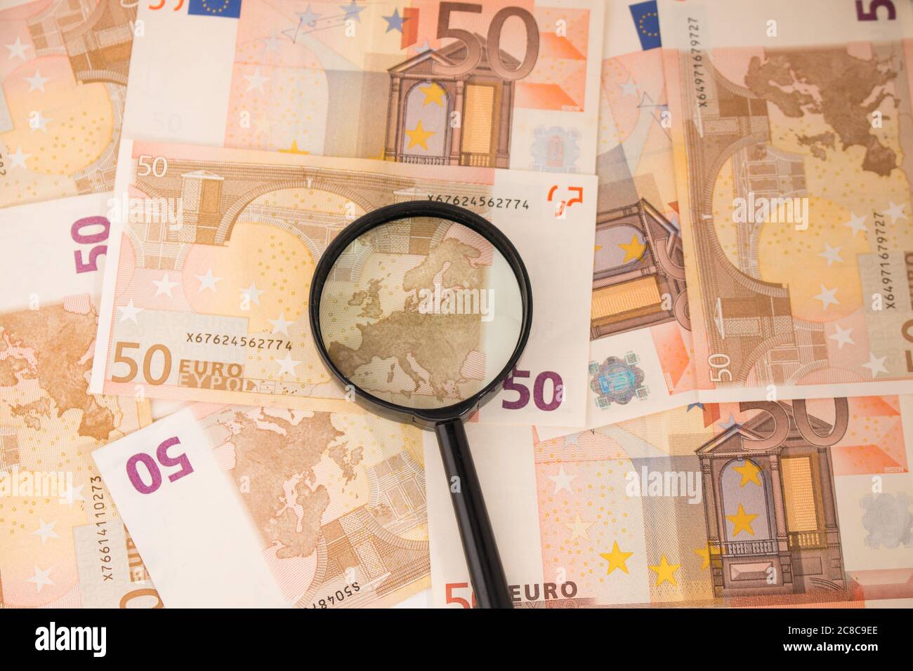 Background with euro money. Magnifier on euro cash. Euro banknotes. 50 ...