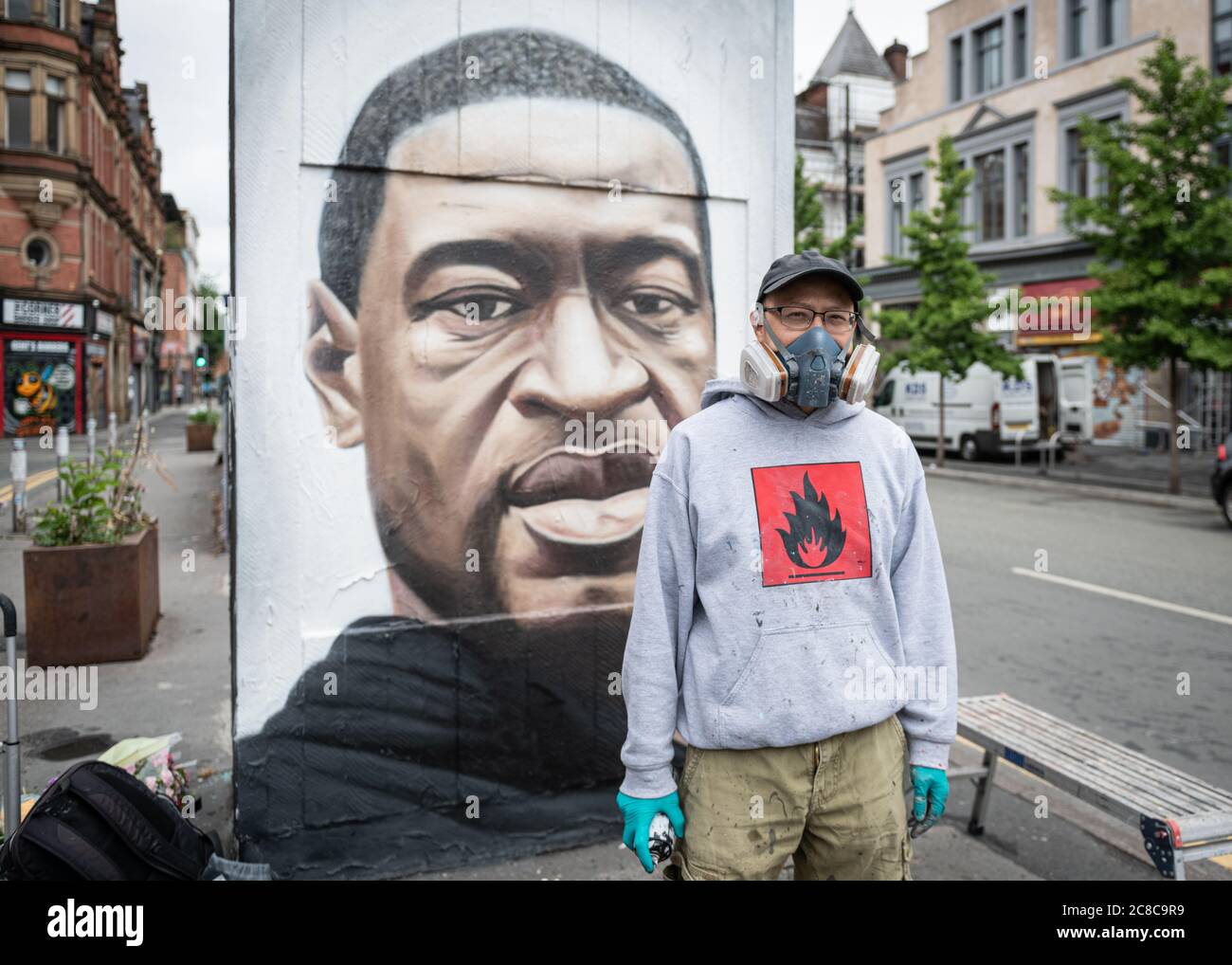 Portrait of Street artist, Akse P19, standing in front of his murals ...