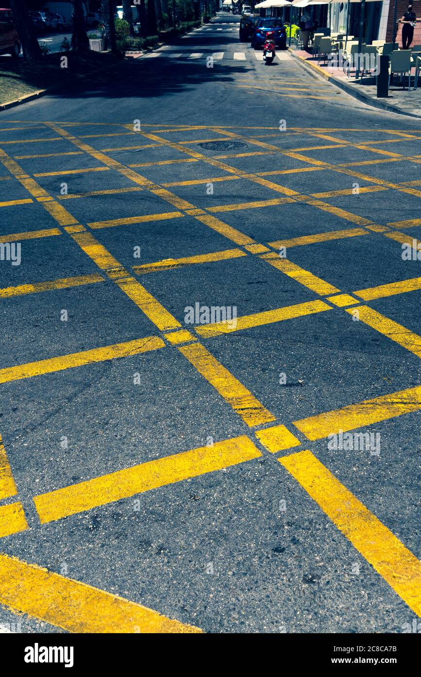 Intersection with yellow markings in the city Stock Photo - Alamy