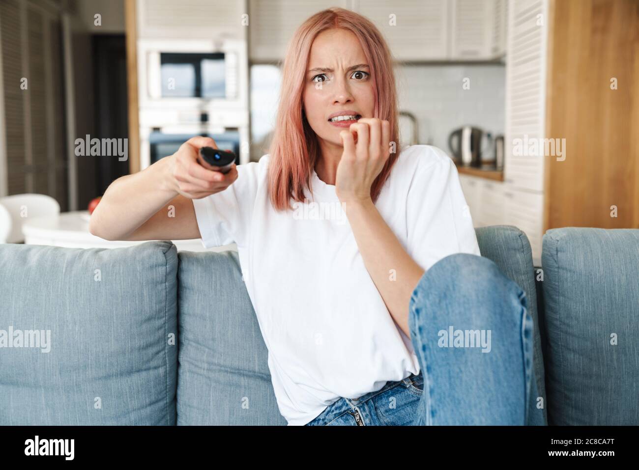 Woman Remote Control Shocked High Resolution Stock Photography and ...