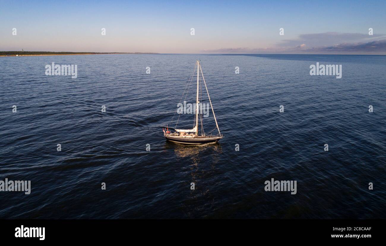 Aerial view of sailboat in the middle of the sea. Boat with coiled ...