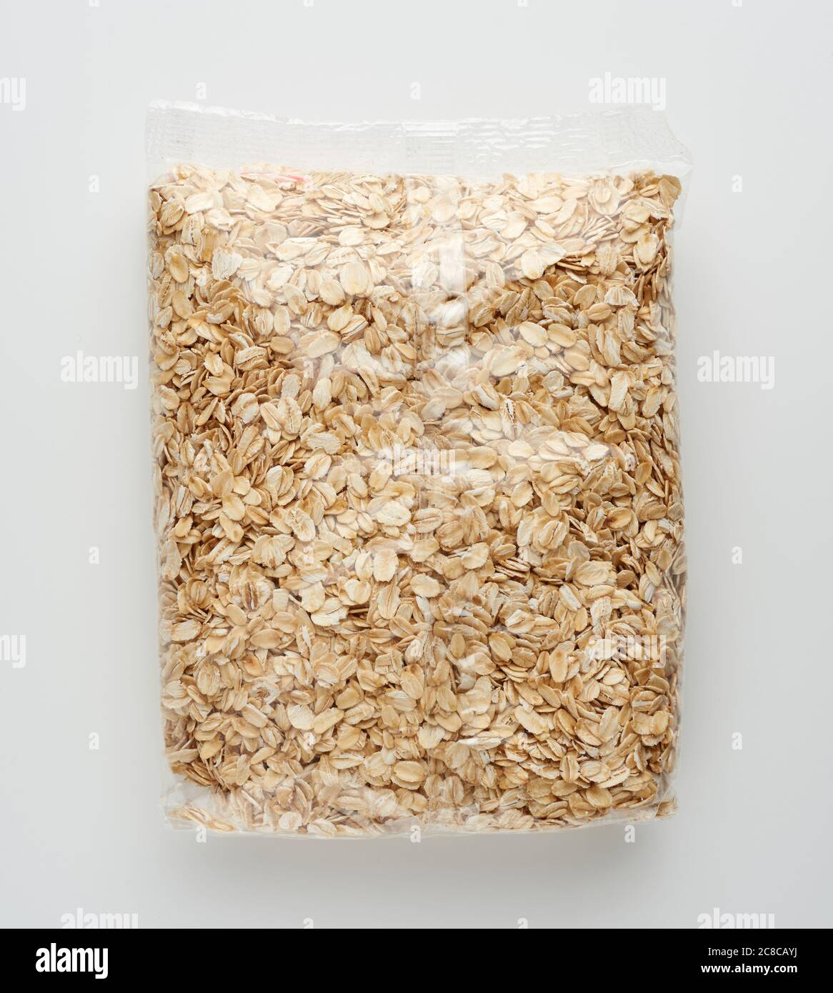 oatmeal in transparent plastic packaging on a white background, store ...