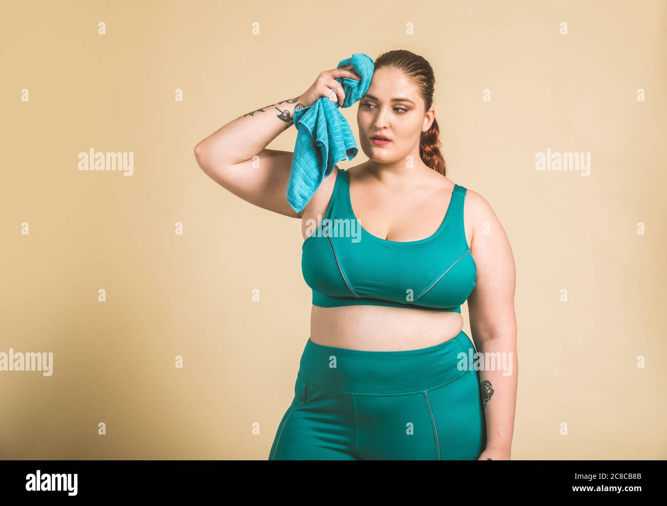 Pretty oversize woman wearing sportswear posing in studio - Beautiful ...