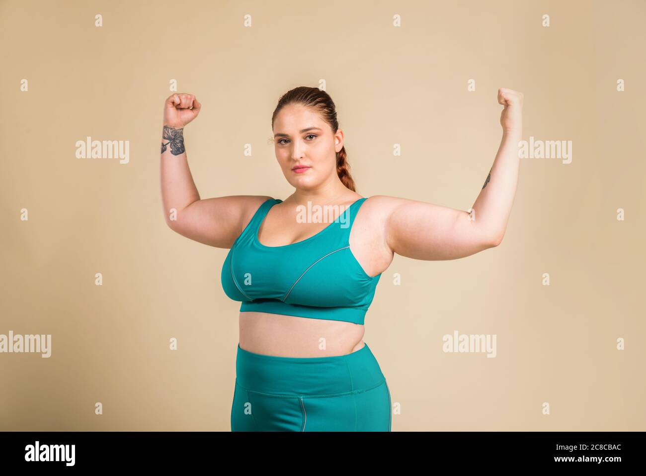 Pretty oversize woman wearing sportswear posing in studio - Beautiful ...