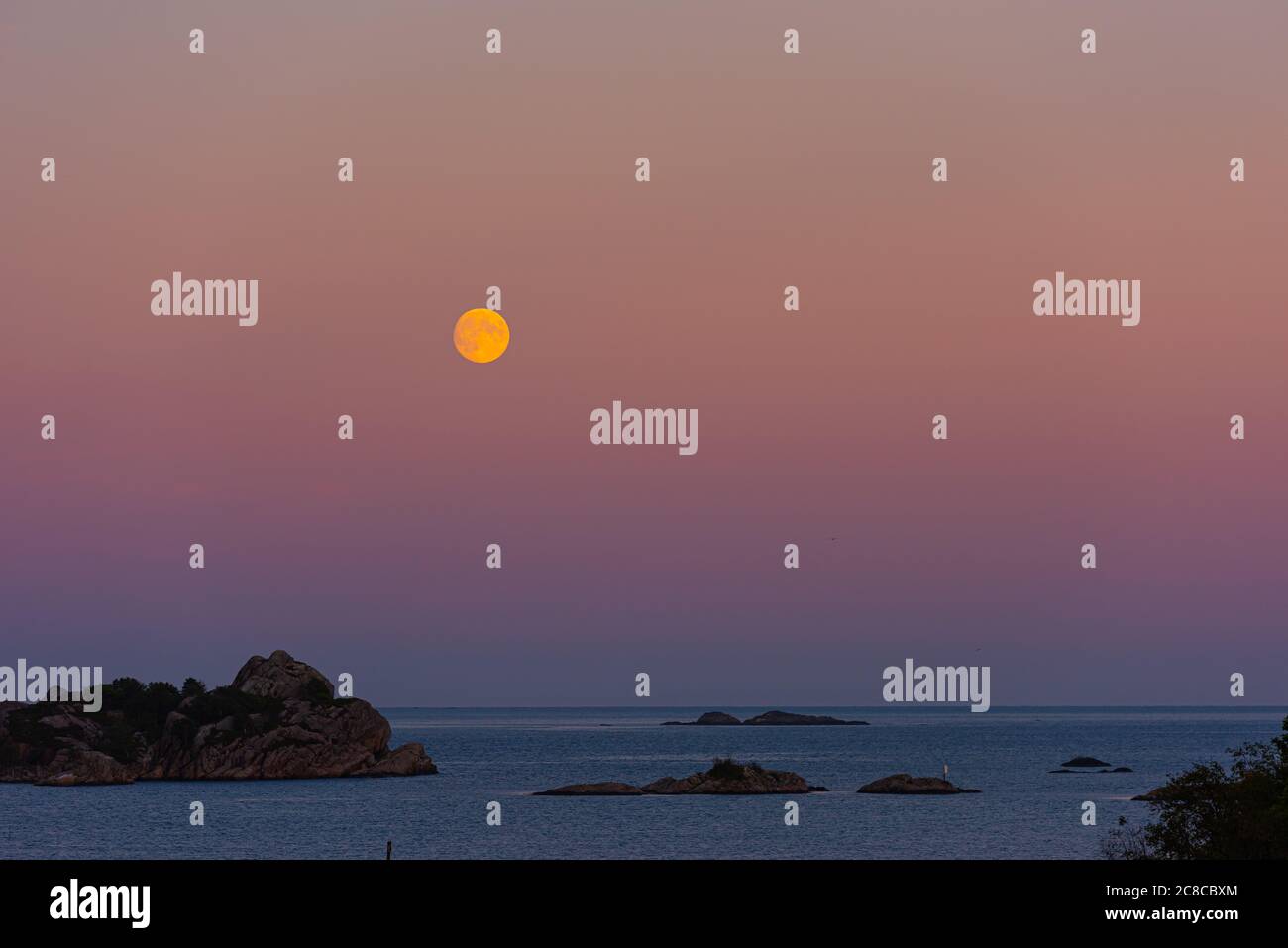 Moonrise over the ocean with cliffs in the foreground Stock Photo - Alamy