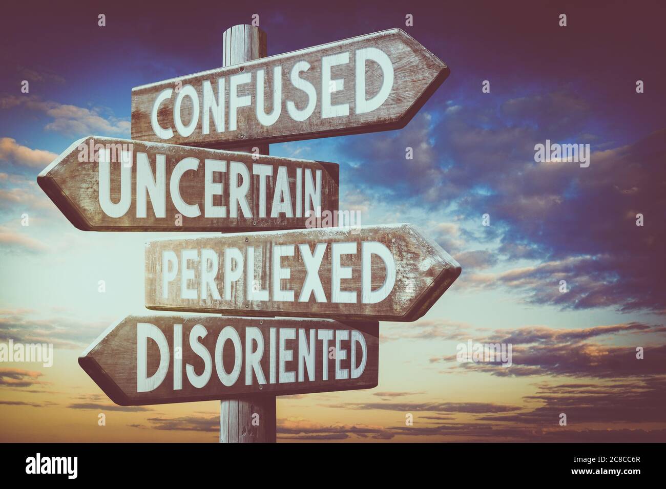 Confused, uncertain, perplexed, disoriented - wooden signpost, roadsign ... Confused, uncertain, perplexed, disoriented - wooden signpost, roadsign ...