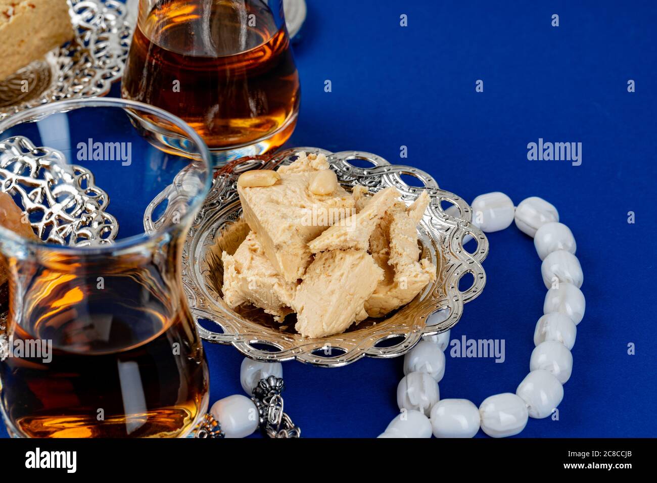Halva dessert with tea cup on blue background Stock Photo - Alamy