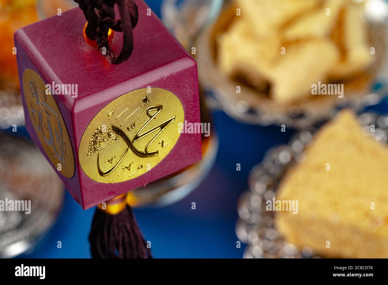 Muslim amulet of bordeux color on rope Stock Photo - Alamy
