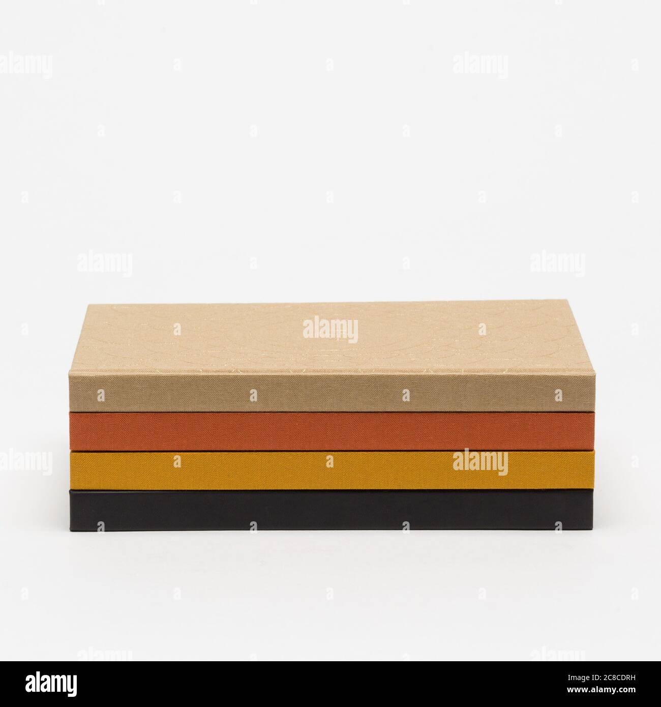 Stack of four colorful notebooks on a white background Stock Photo - Alamy