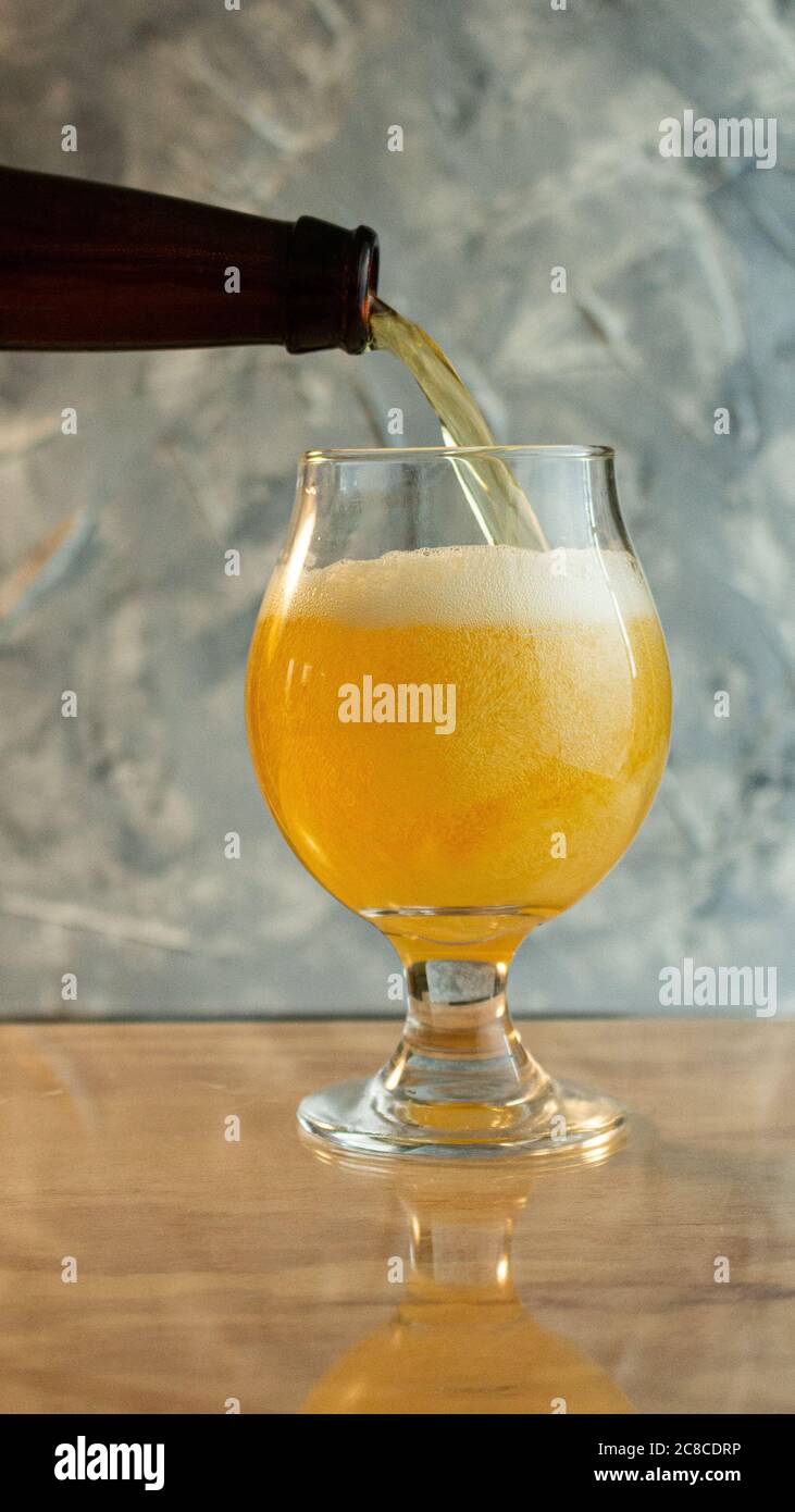 Beer being poured Stock Photo - Alamy