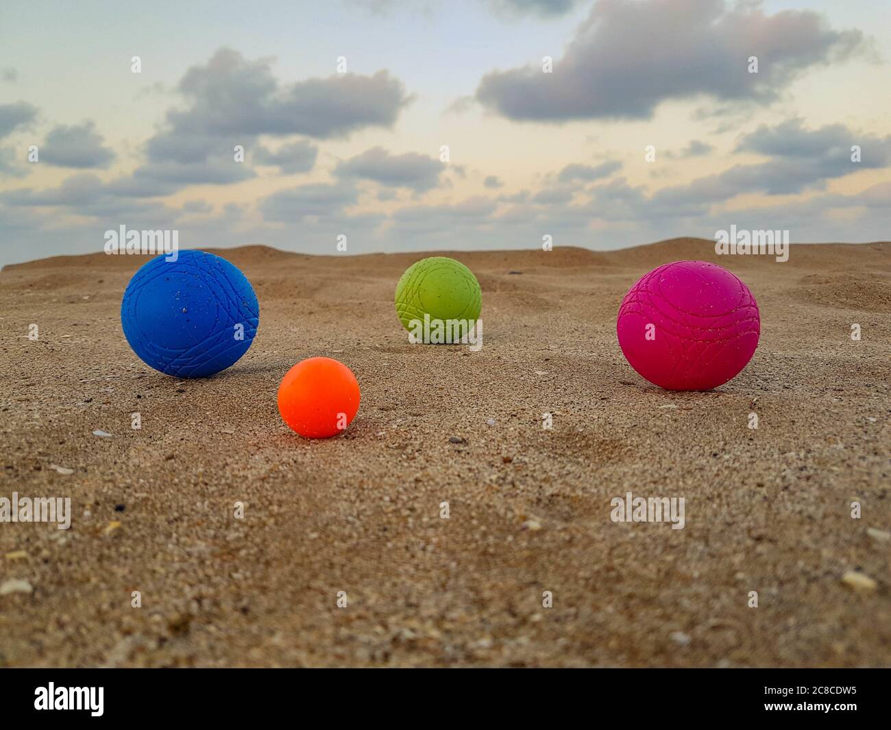 Closeup of colorful beach balls on the sand at the beach Stock Photo ...