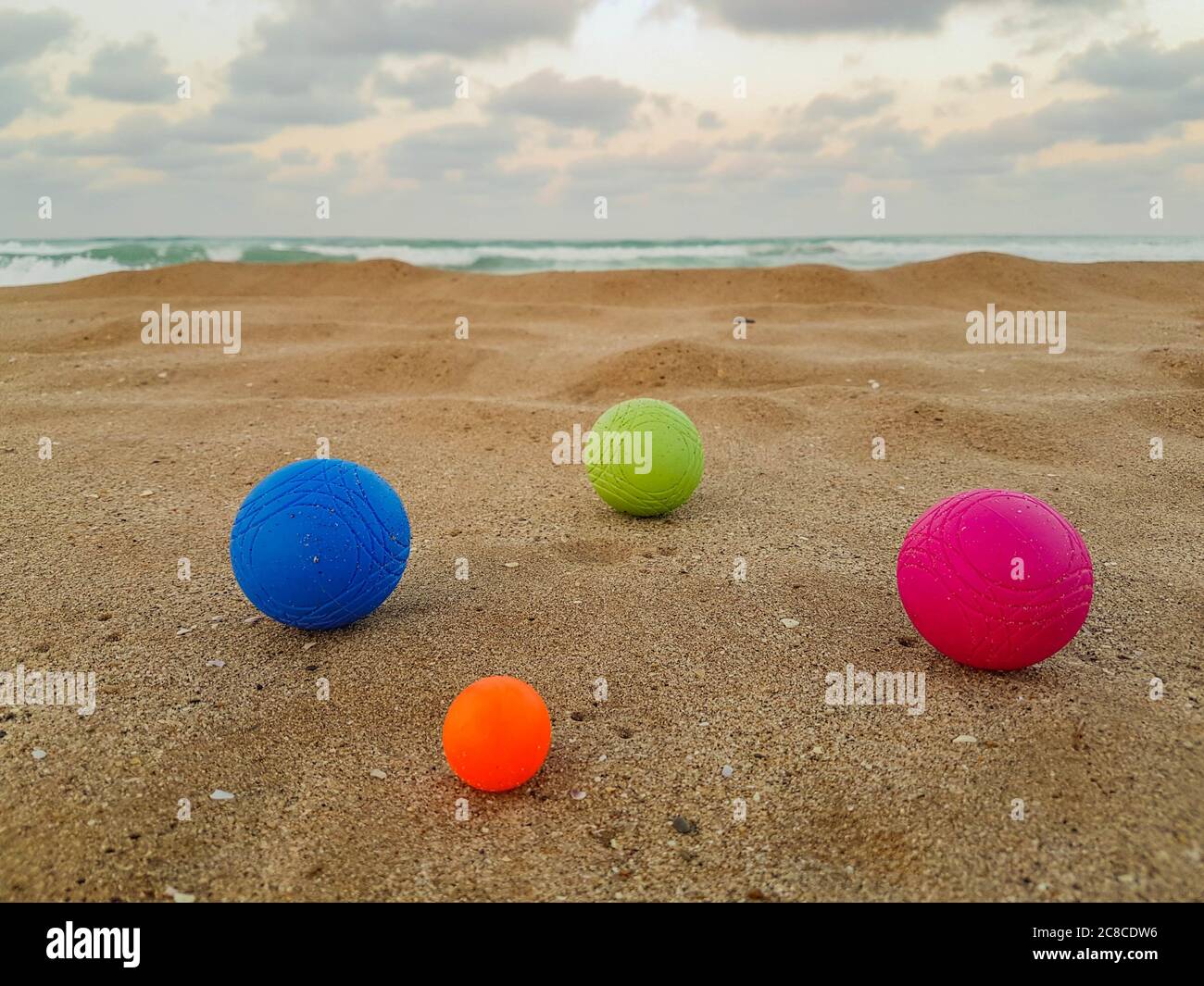 Closeup of colorful beach balls on the sand at the beach Stock Photo ...
