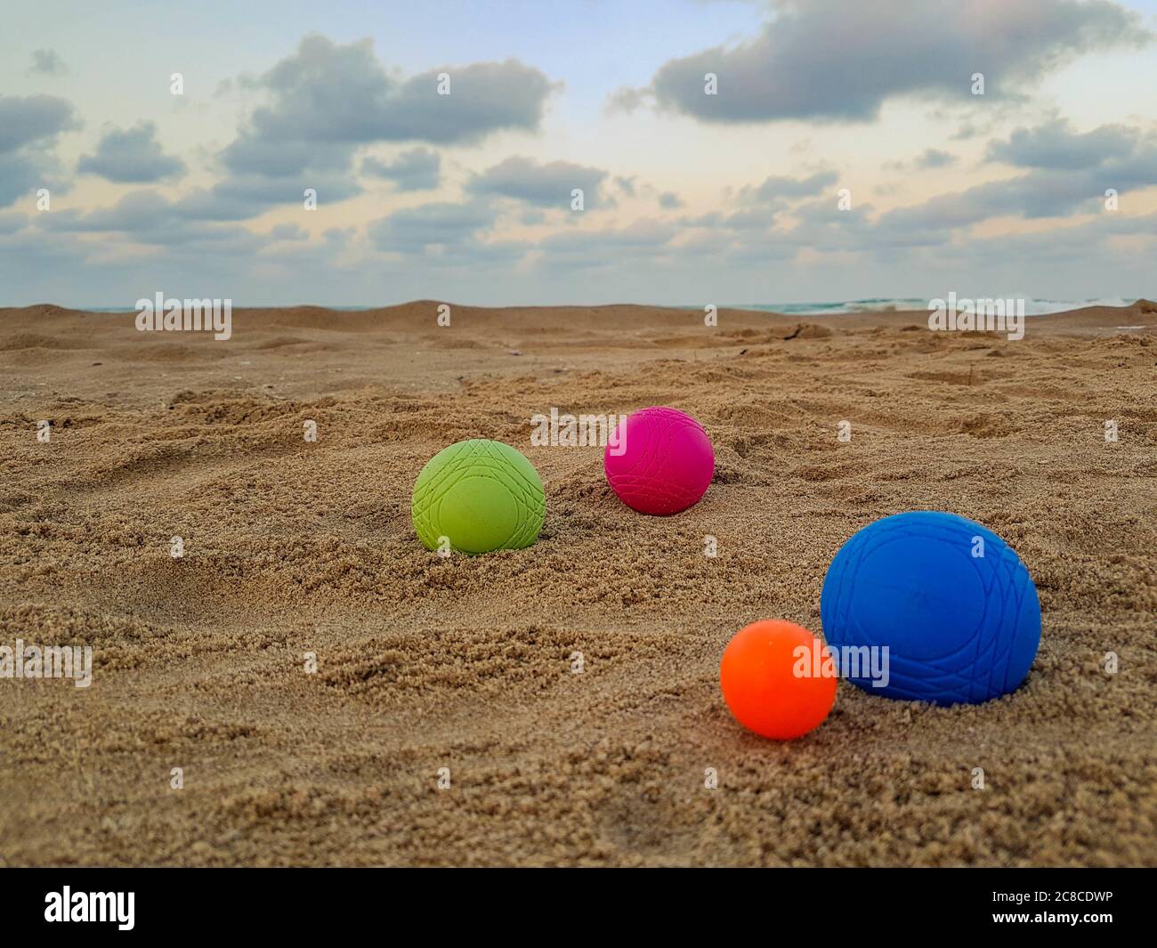 Closeup of colorful beach balls on the sand at the beach Stock Photo ...
