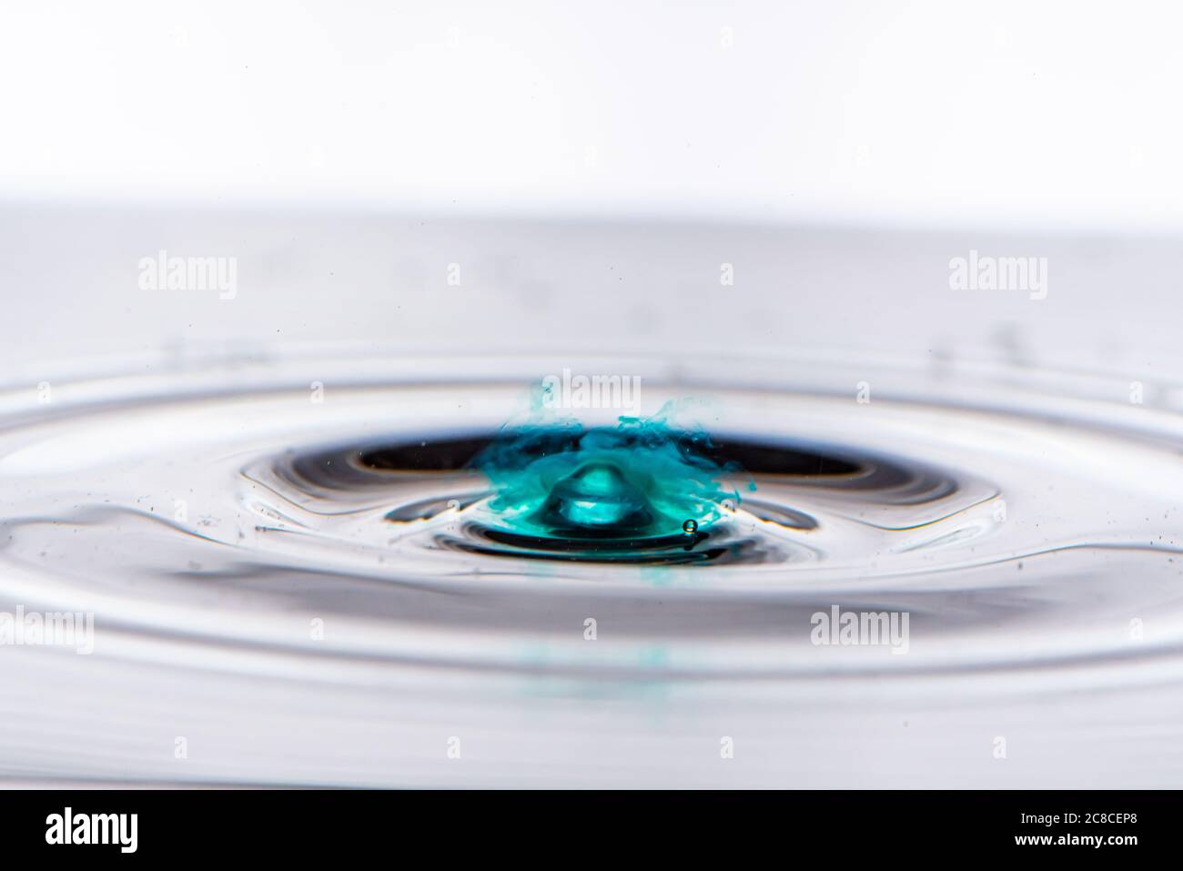 Green colored water drop splashing in clear water Stock Photo - Alamy