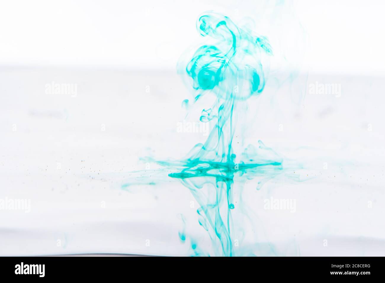 Green colored water drop splashing in clear water Stock Photo - Alamy
