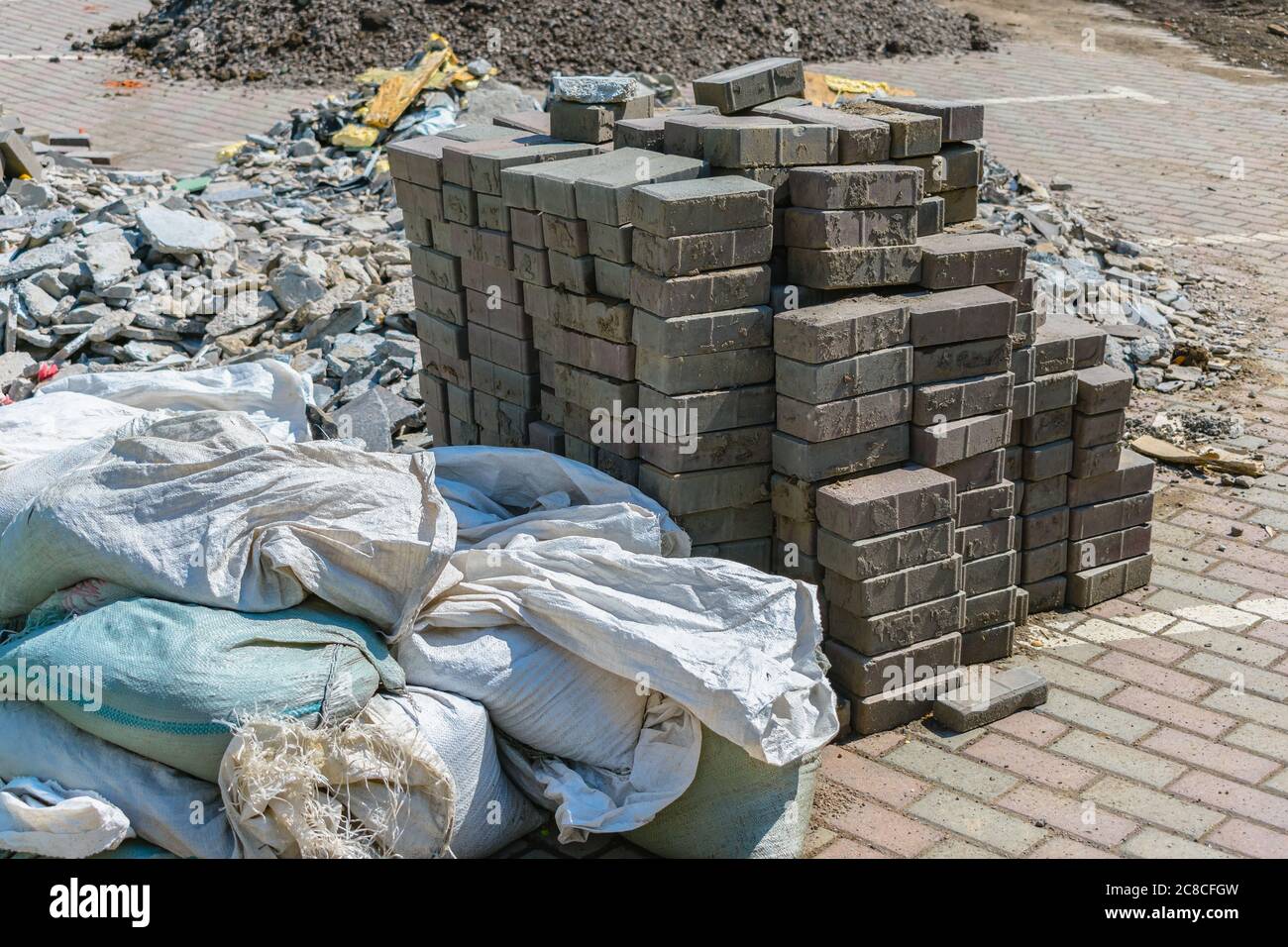 Construction waste in bags, broken stone and a pile of bricks during ...
