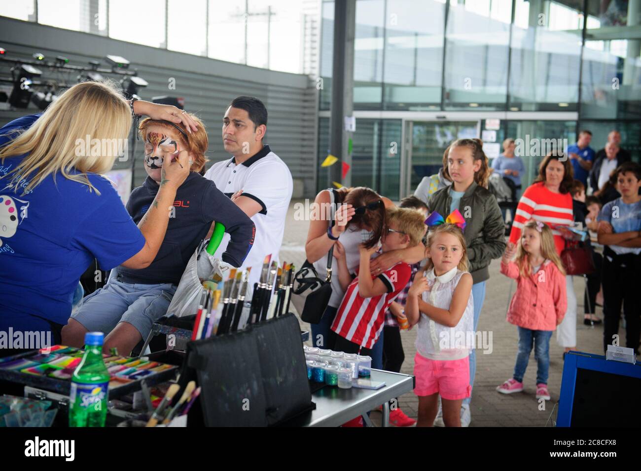 Face painting children at a family fun day. Face paint fun and many ...