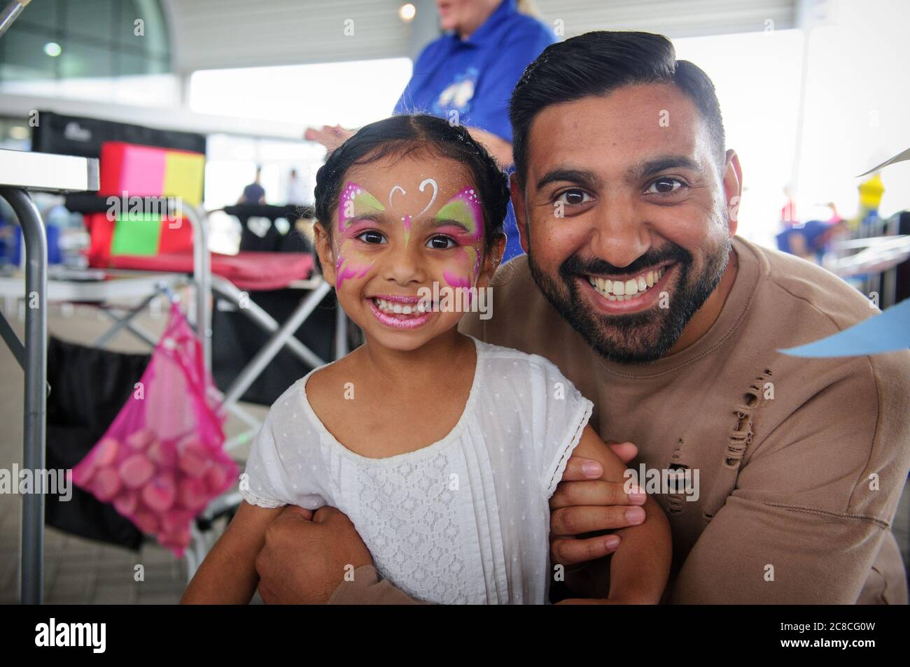 Face painting children at a family fun day. Face paint fun and many ...