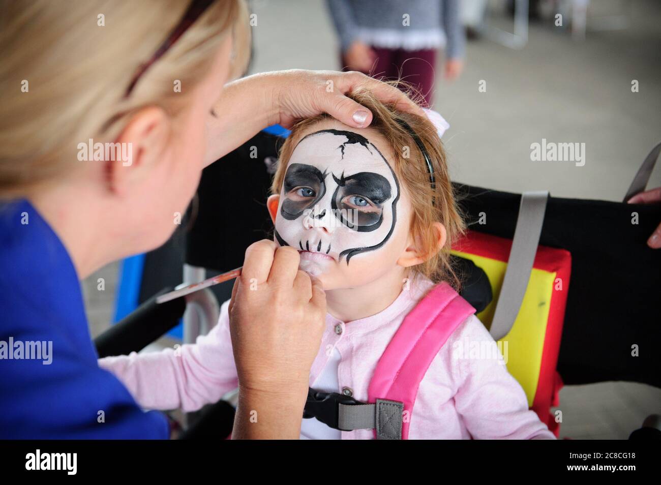 Face painting children at a family fun day. Face paint fun and many ...