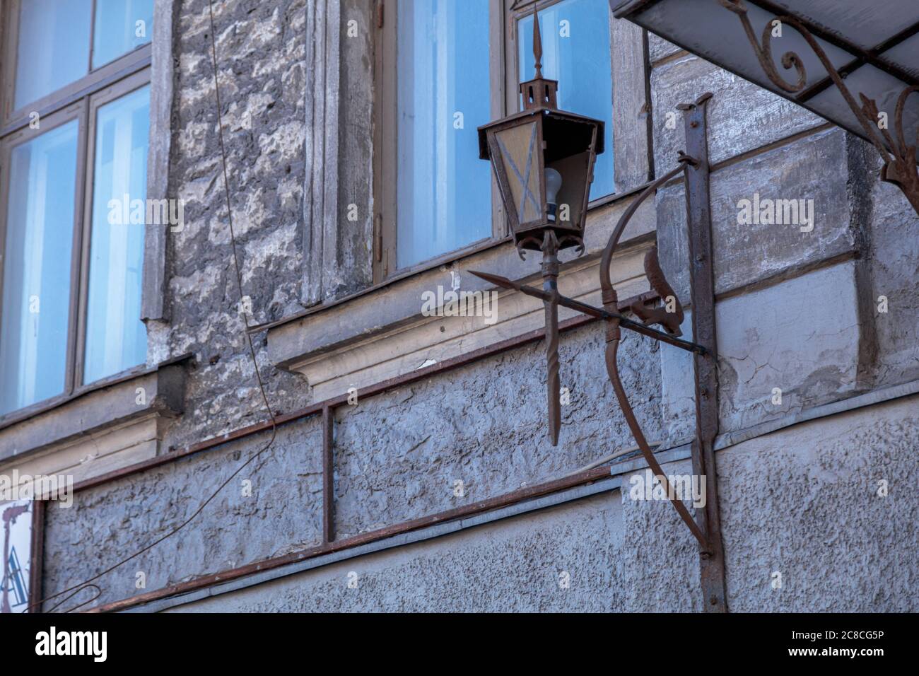 Old, broken lantern on the wall of a house in Tallinn. High quality ...