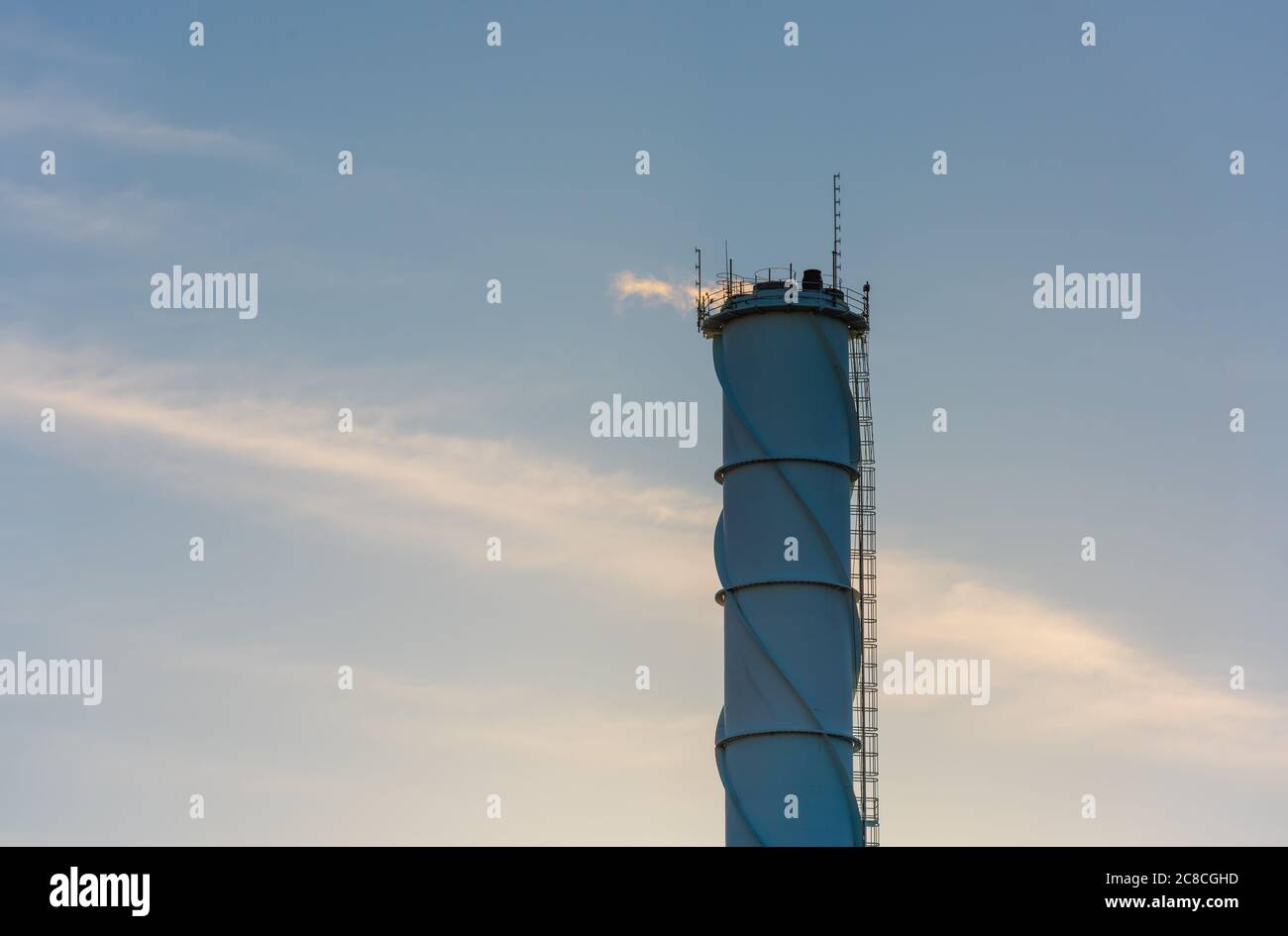 Tall large funnel of a heating plant Stock Photo - Alamy