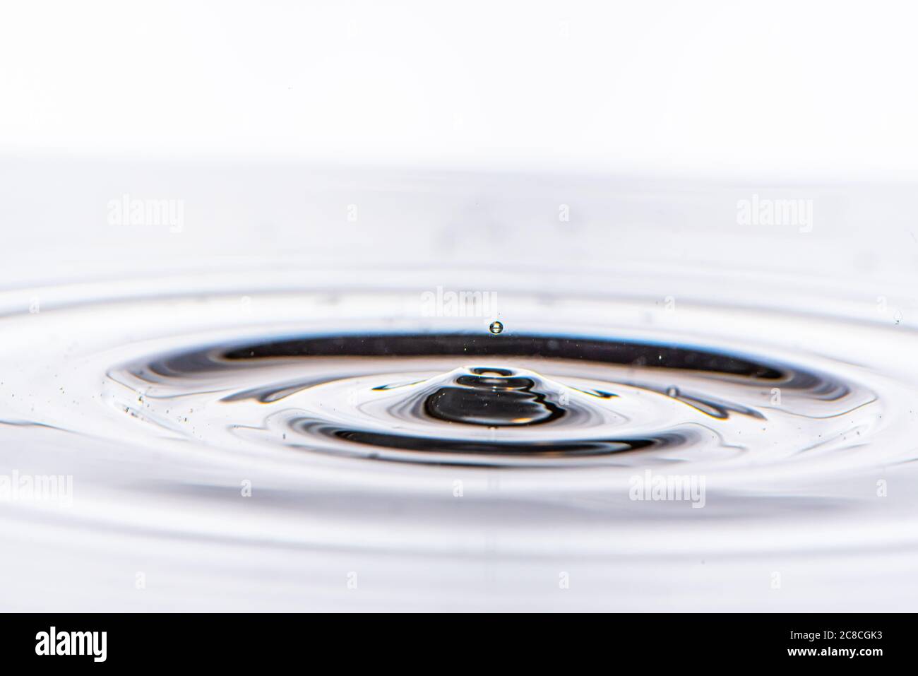 Water drop splashing in clear water Stock Photo - Alamy