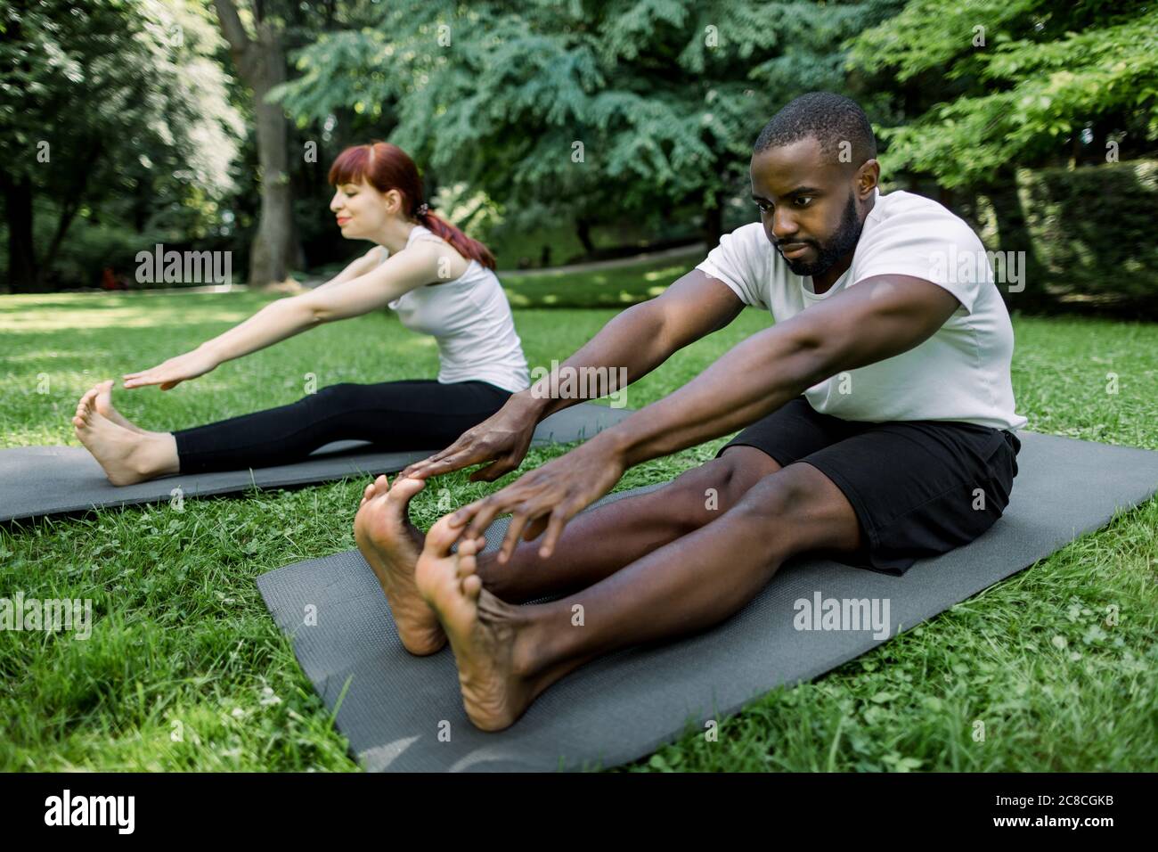 Image of smiling fitness multiethnic couple, wearing sports clothes ...