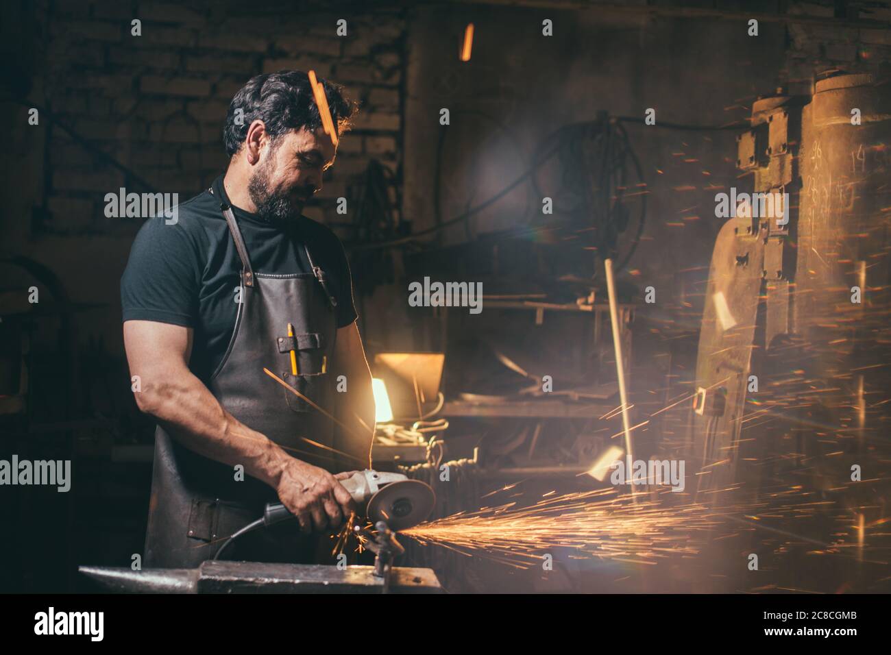 Worker Using Angle Grinder in Factory and throwing sparks Stock Photo ...