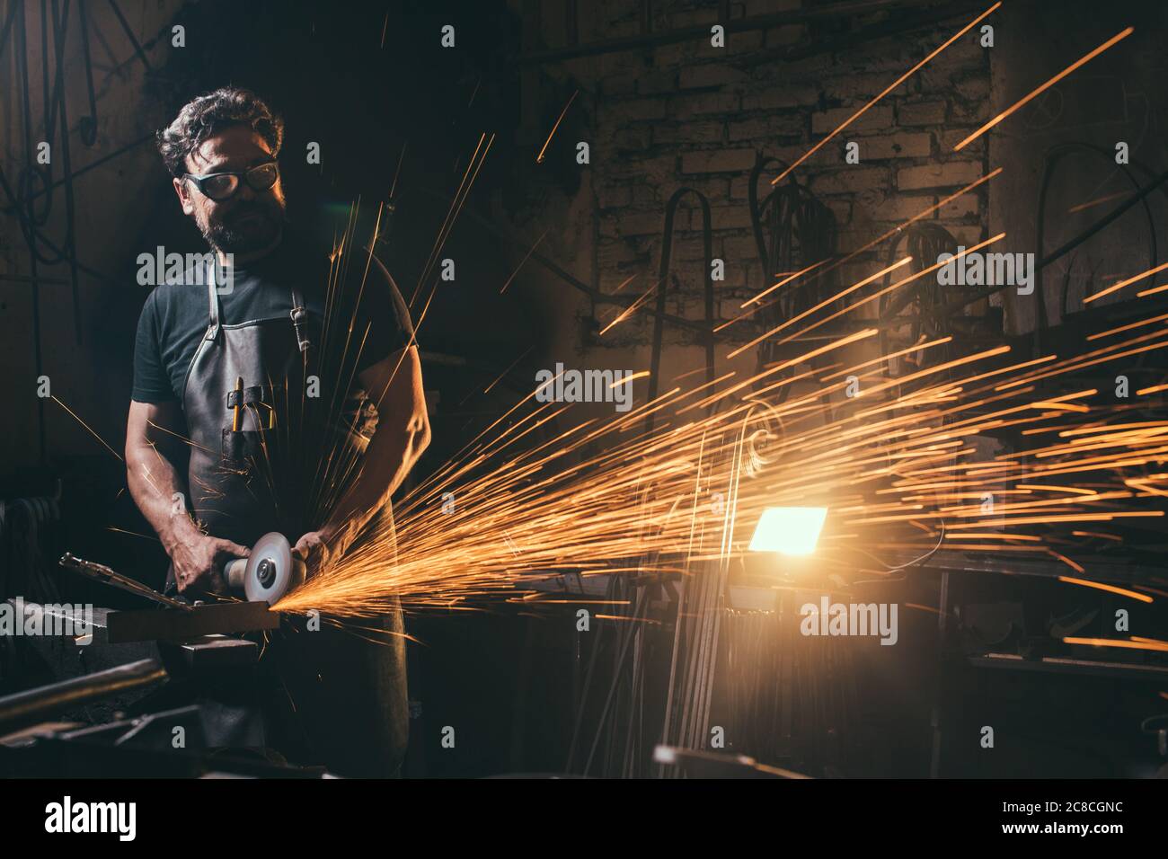 Worker Using Angle Grinder in Factory and throwing sparks Stock Photo ...
