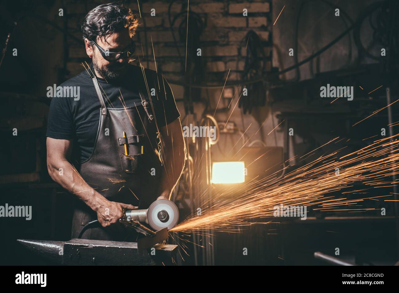 Worker Using Angle Grinder in Factory and throwing sparks Stock Photo ...