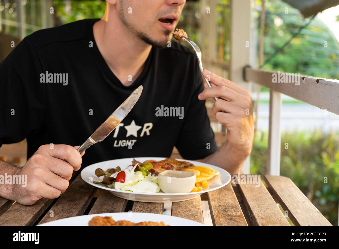 Guy eating steak dinner hi-res stock photography and images - Alamy