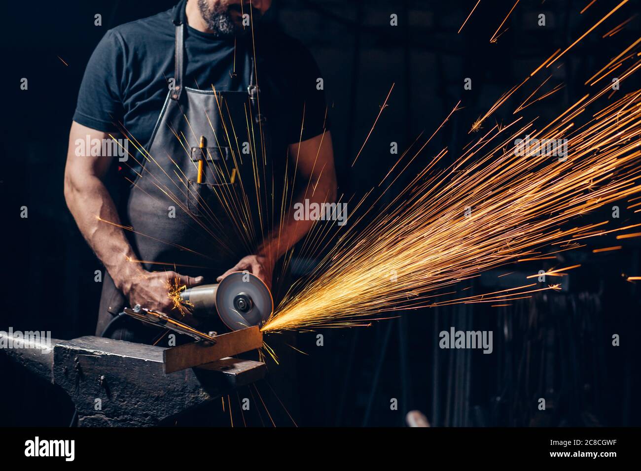 Worker Using Angle Grinder in Factory and throwing sparks Stock Photo ...