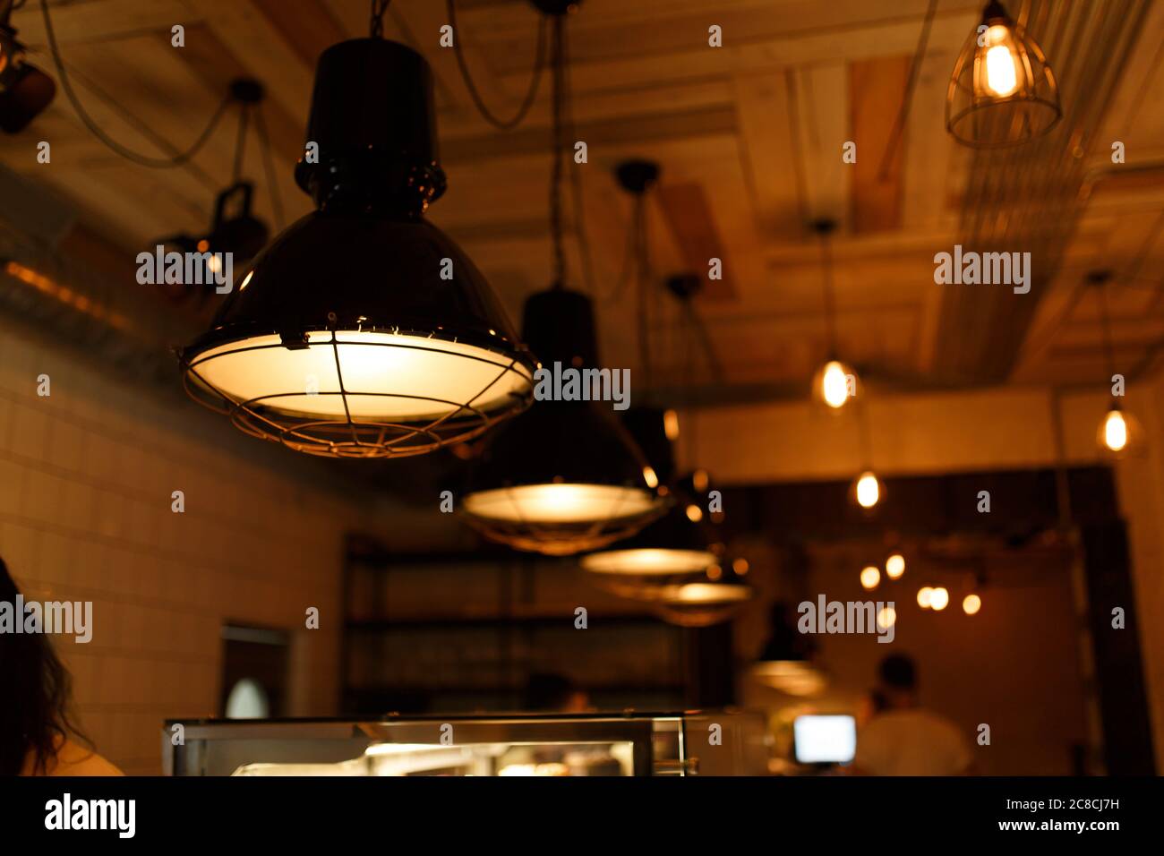 Stylish lighting lamps over a bar counter in a loft hookah bar Stock ...