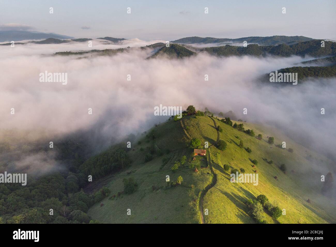 Summer sunrise in the Transylvanian village. Aerial foggy landscape in ...