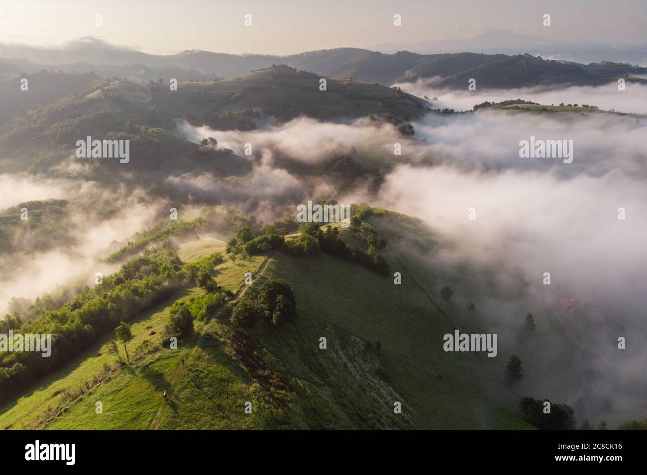 Summer sunrise in the Transylvanian village. Aerial foggy landscape in ...