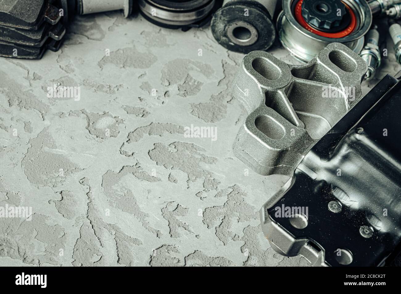 Car parts on grey textured concrete background Stock Photo - Alamy