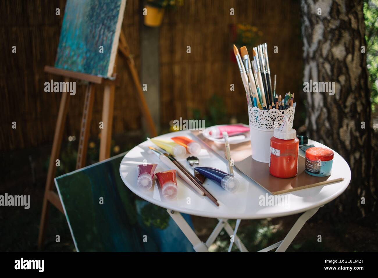 Paint tubes and brushes on table outdoor Stock Photo - Alamy