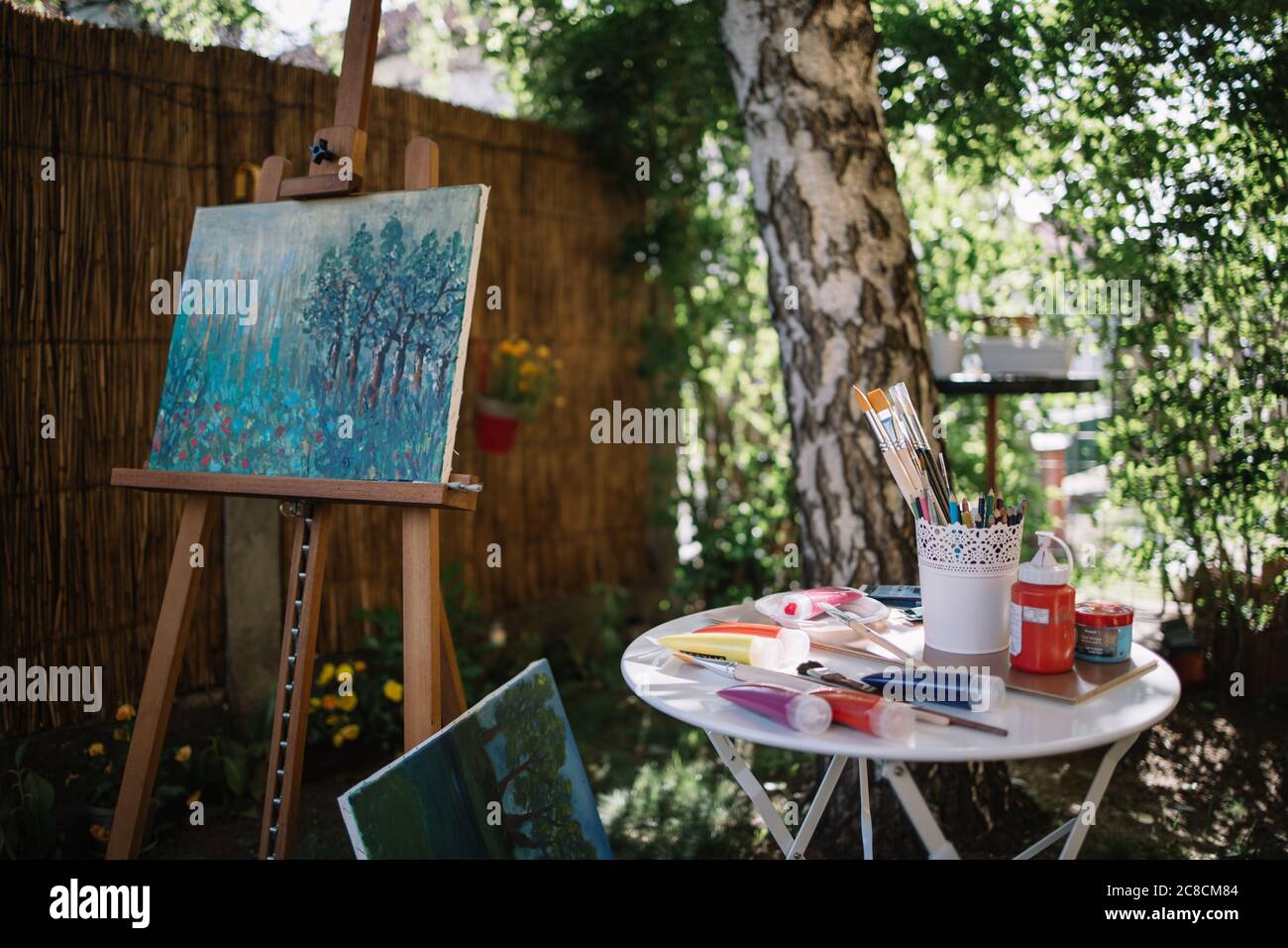 Artist's workshop in backyard with tree and plants Stock Photo - Alamy