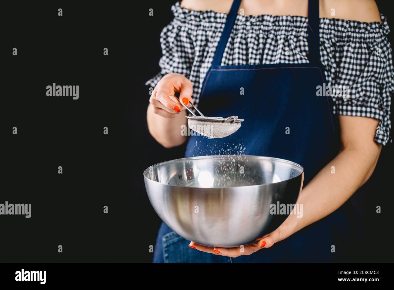 Beautiful female baker sifting flour hi-res stock photography and ...