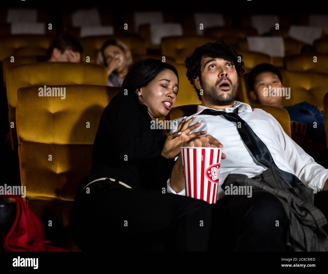 Audience sit in a cinema and watch horror movie Stock Photo - Alamy