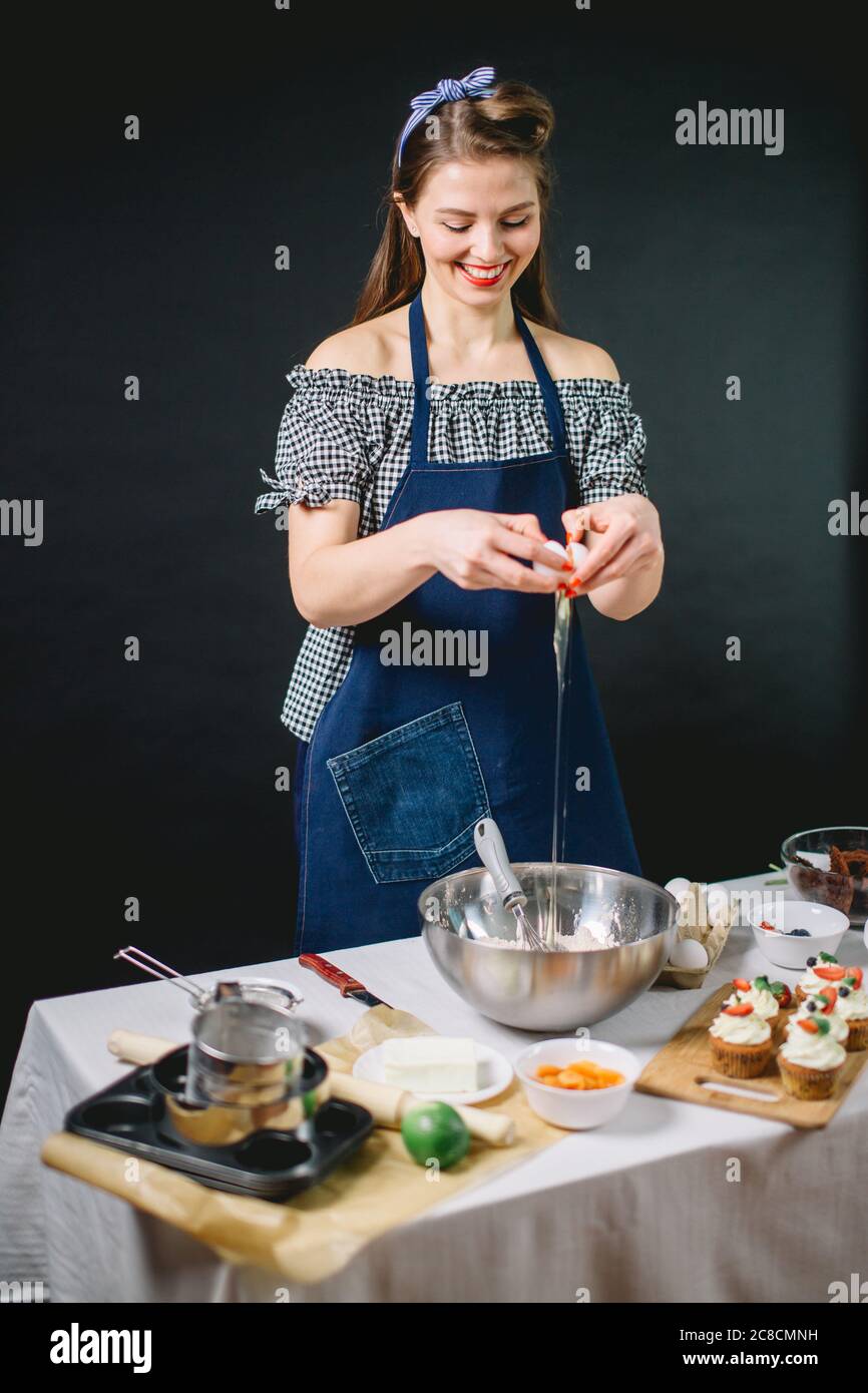 happy pastry woman breaking an egg , showing step by step Cake cooking ...