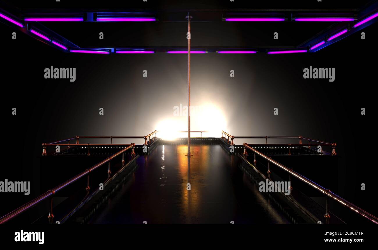 An empty strip club dancing stage with a pole and brass railings and ...